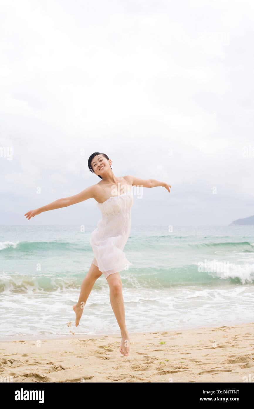 A woman dancing at the beach Stock Photo - Alamy