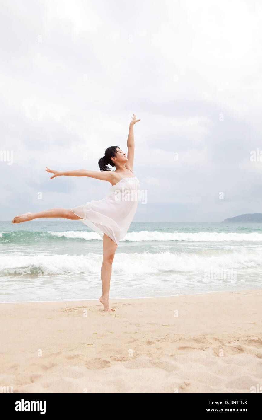 A woman dancing at the beach Stock Photo - Alamy