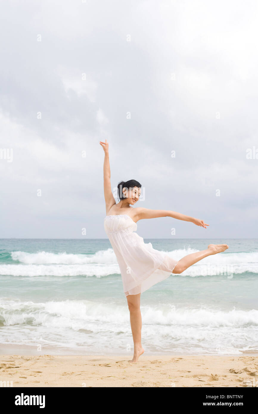 A woman dancing at the beach Stock Photo - Alamy