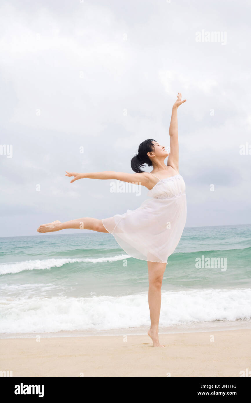 A woman dancing at the beach Stock Photo - Alamy