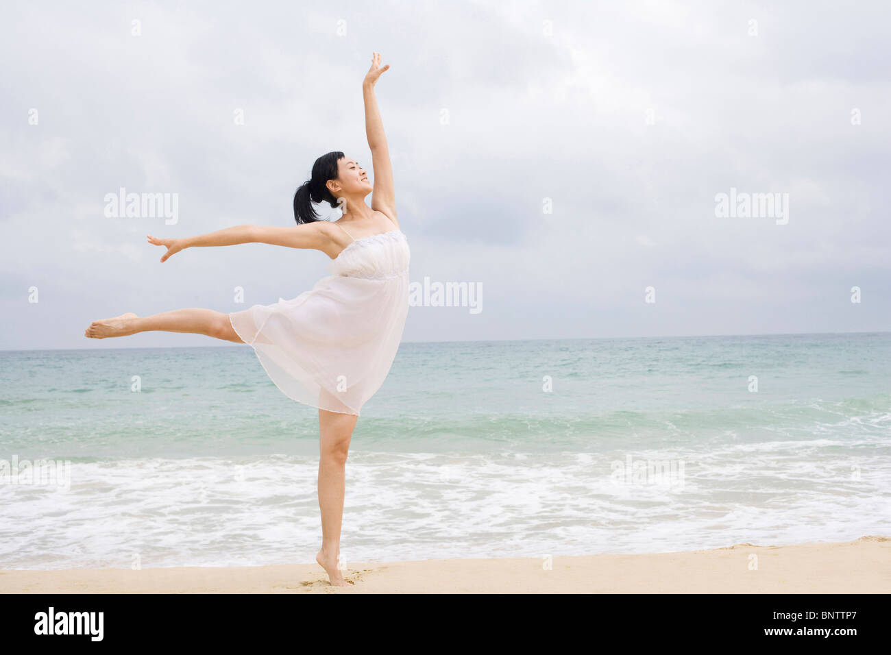 A woman dancing at the beach Stock Photo - Alamy