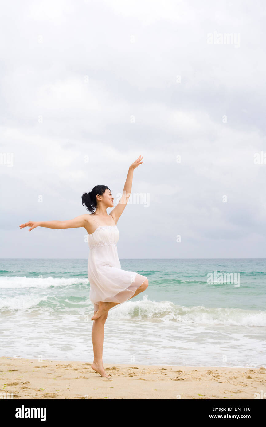 A woman dancing at the beach Stock Photo - Alamy