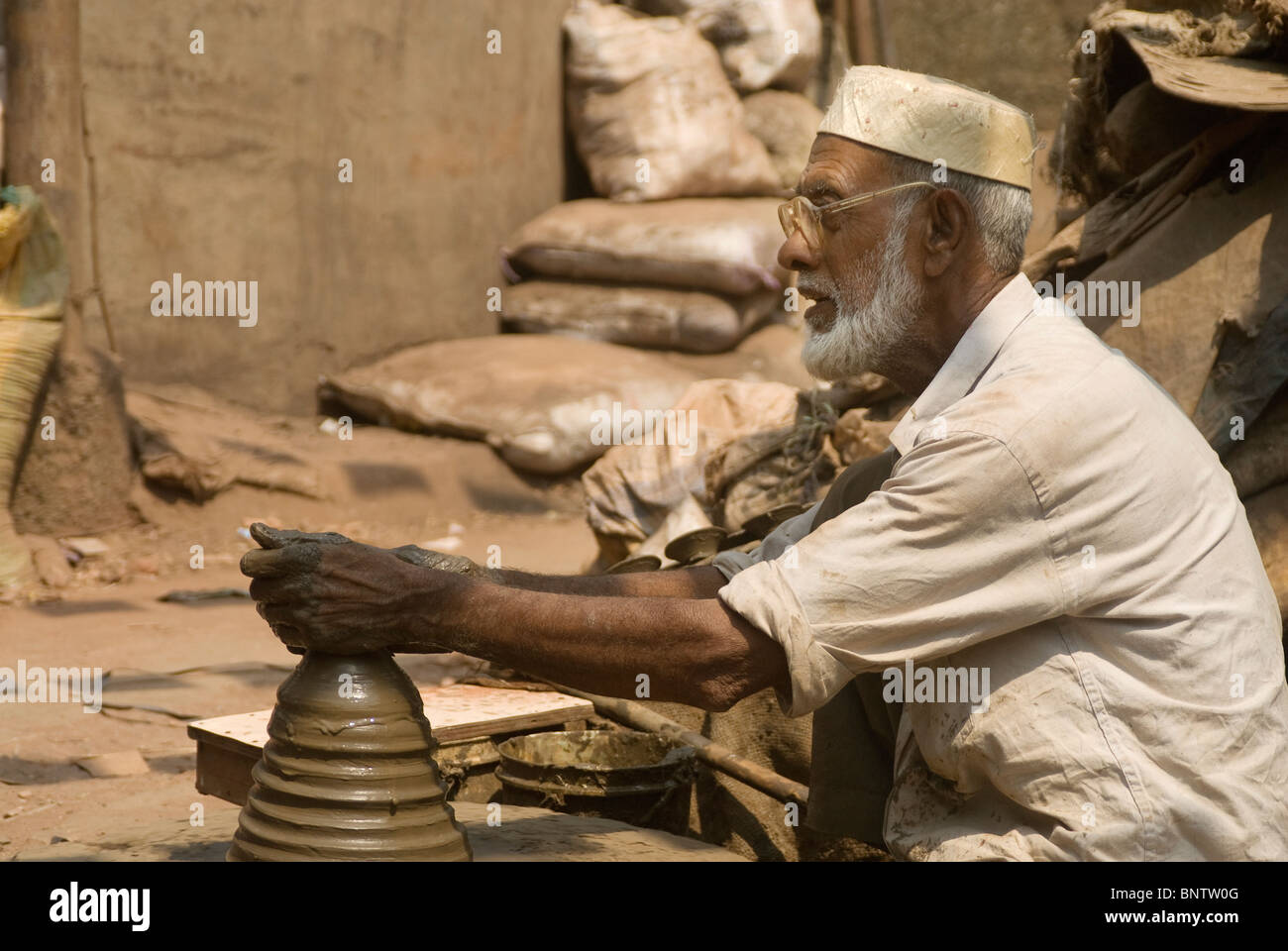 Indian Potter crafting earthen pots using traditional methods ...