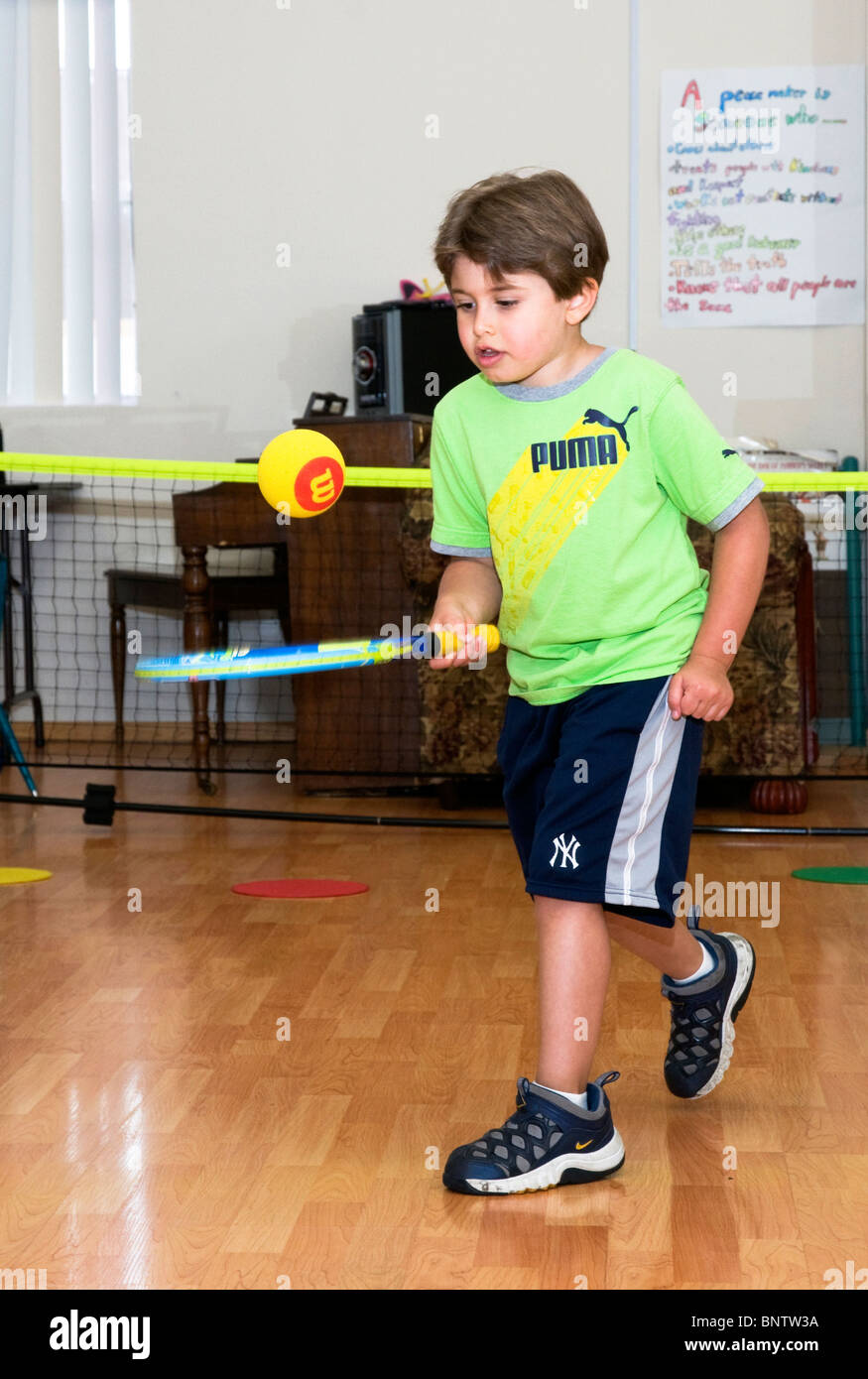 A boy play with racket and yellow ball.Tennis lesson for kids ...
