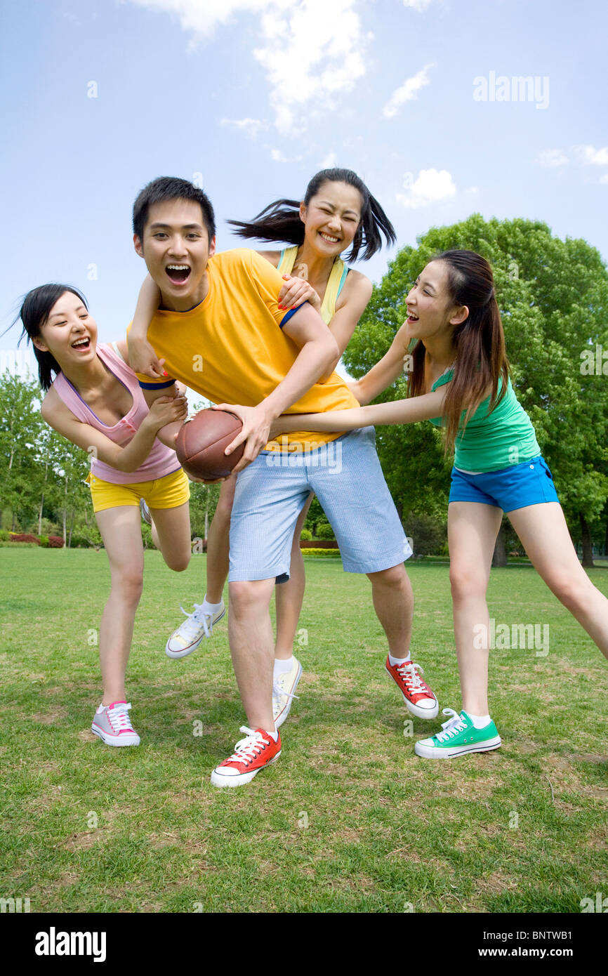 Group of friends playing American Football Stock Photo - Alamy