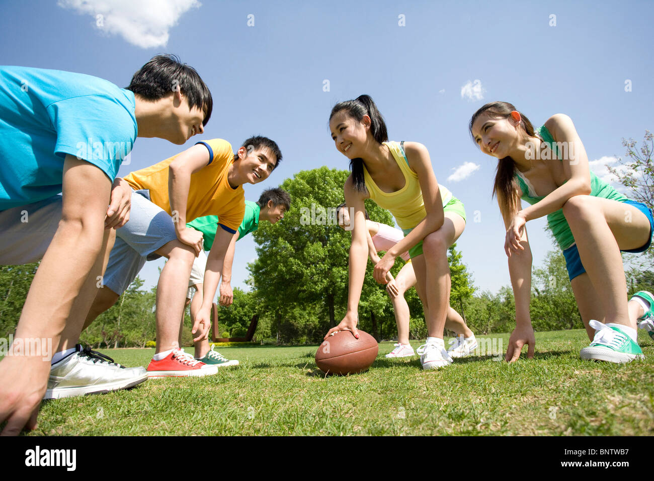Group of friends playing American Football Stock Photo - Alamy
