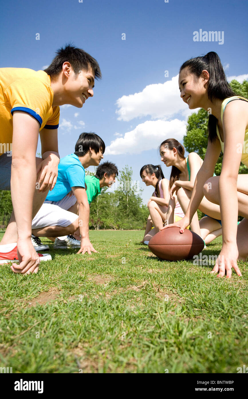 Group of friends playing American Football Stock Photo - Alamy