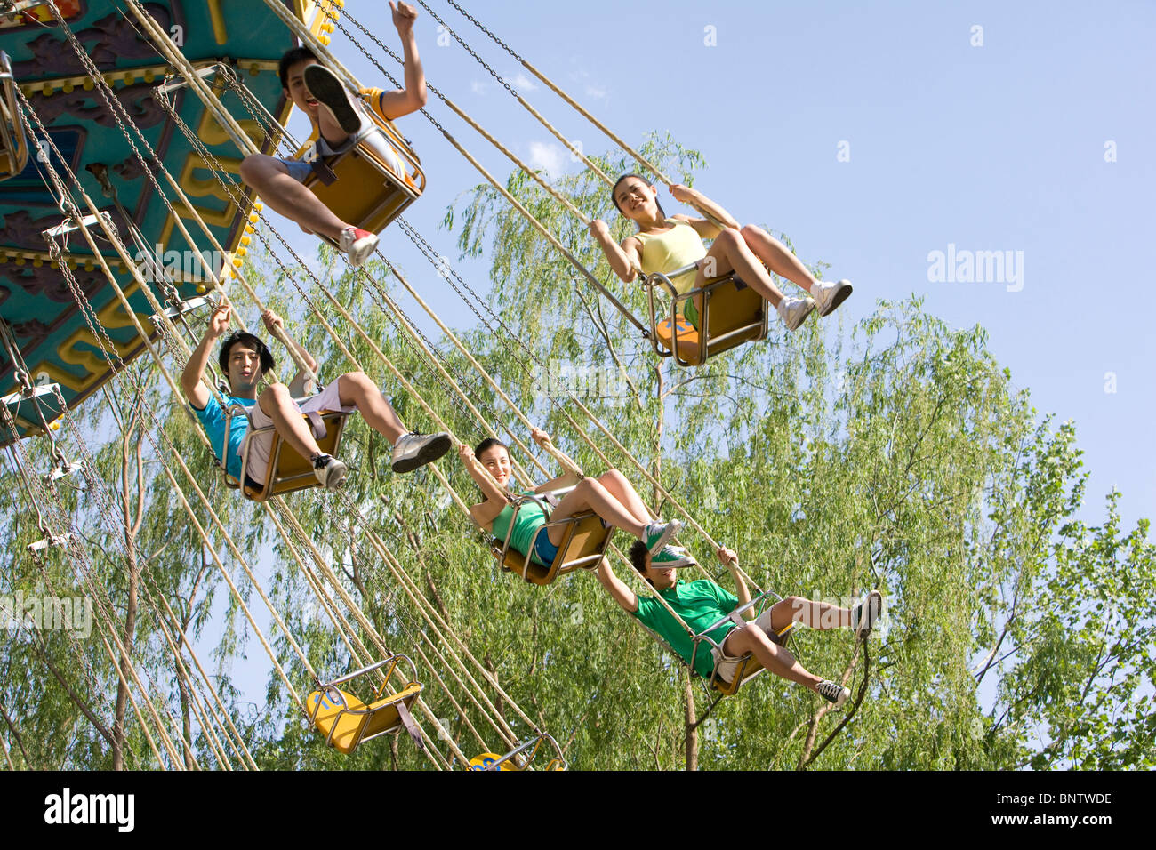 Young people having fun at the amusement park Stock Photo - Alamy
