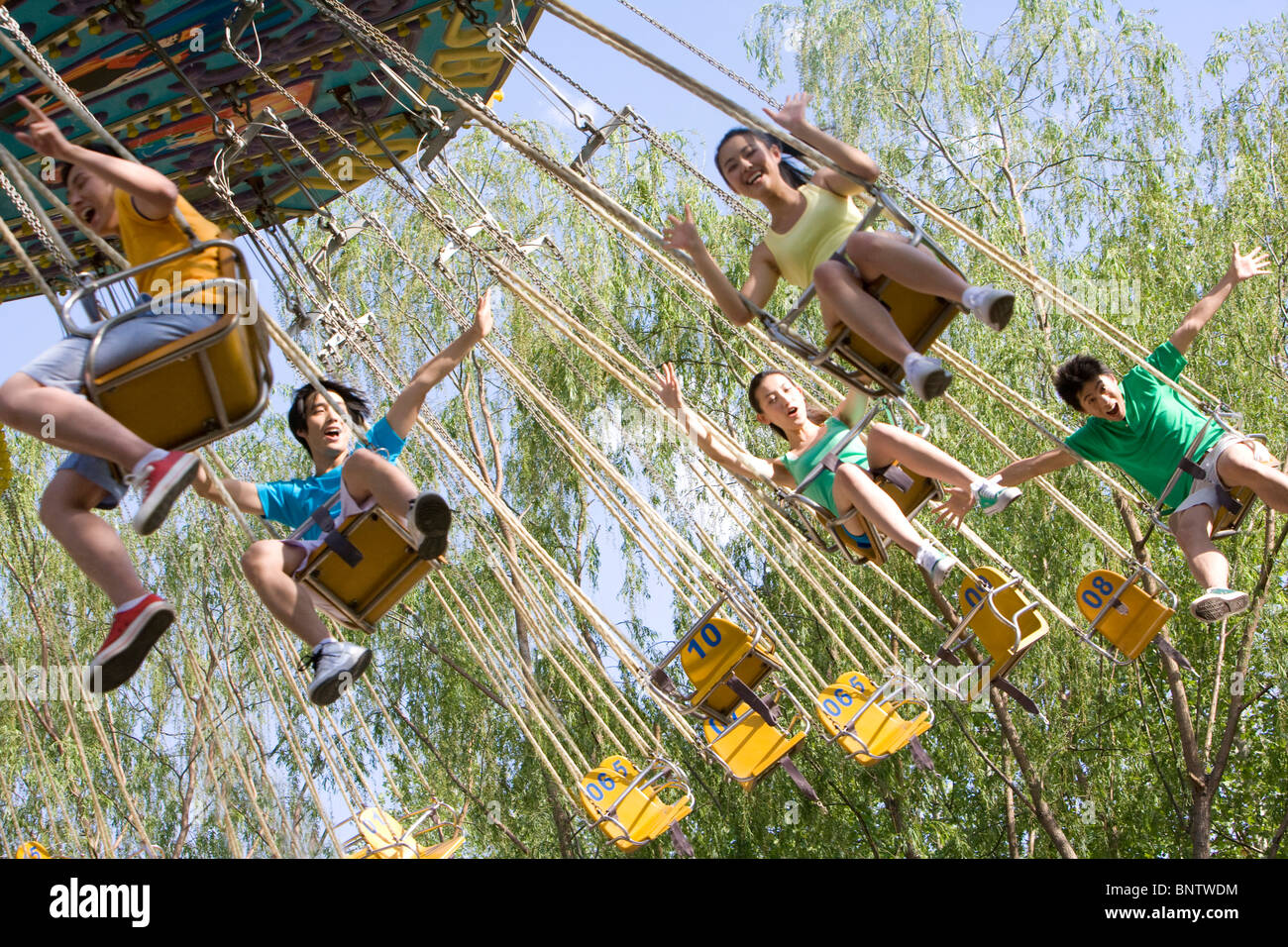 Young people having fun at the amusement park Stock Photo - Alamy