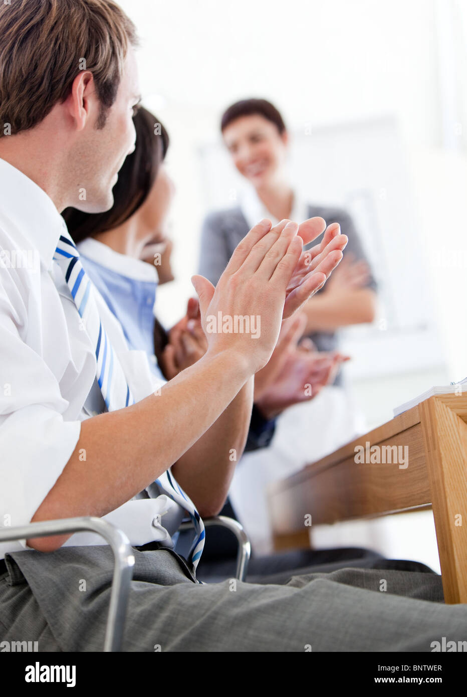 Jolly business people applauding a good presentation Stock Photo - Alamy