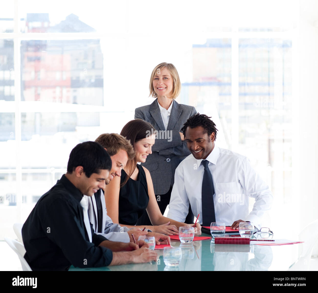 Female manager with her team in a meeting Stock Photo - Alamy