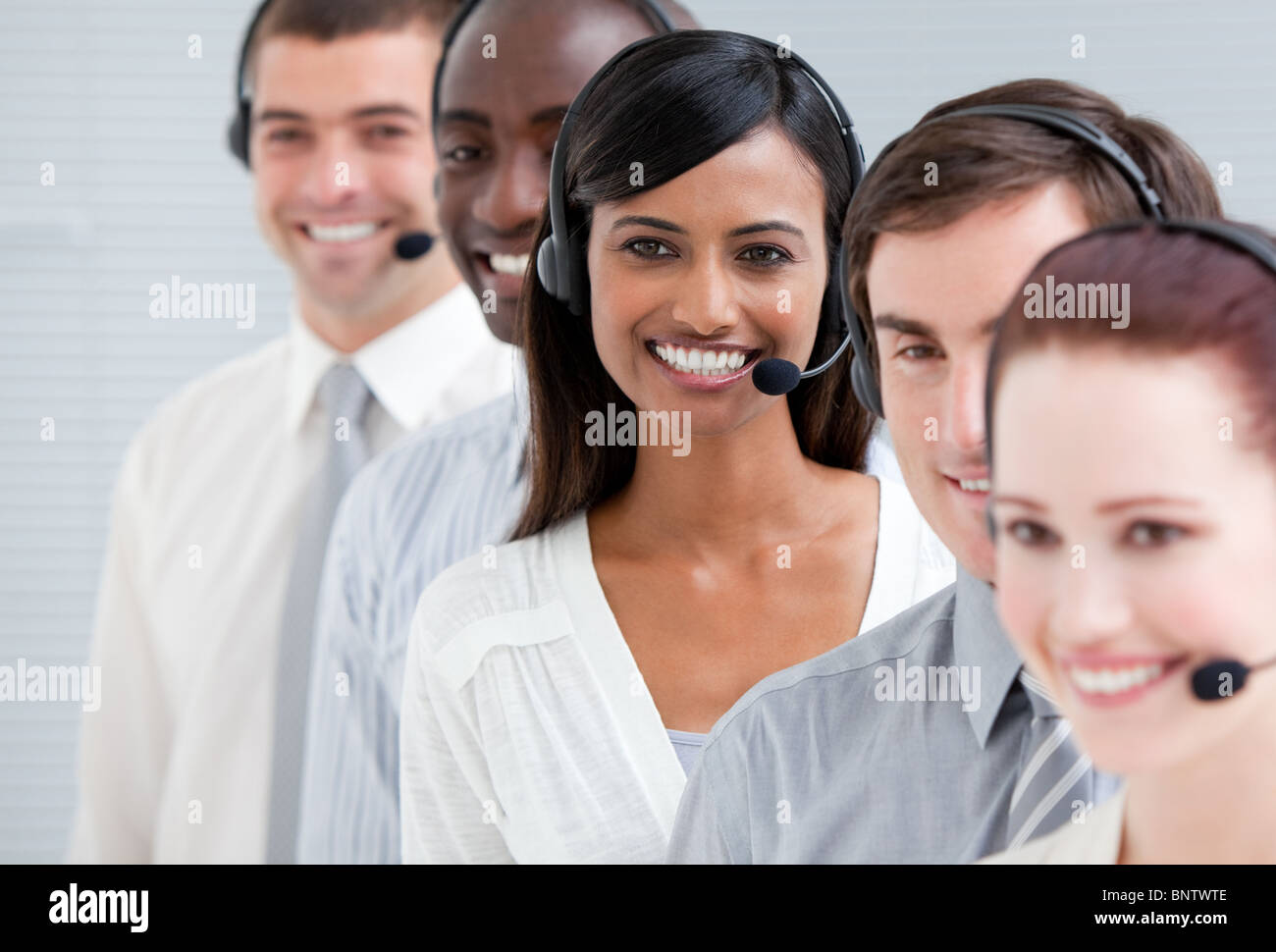 Multi Ethnic Customer Service Representatives Standing In A Line Stock