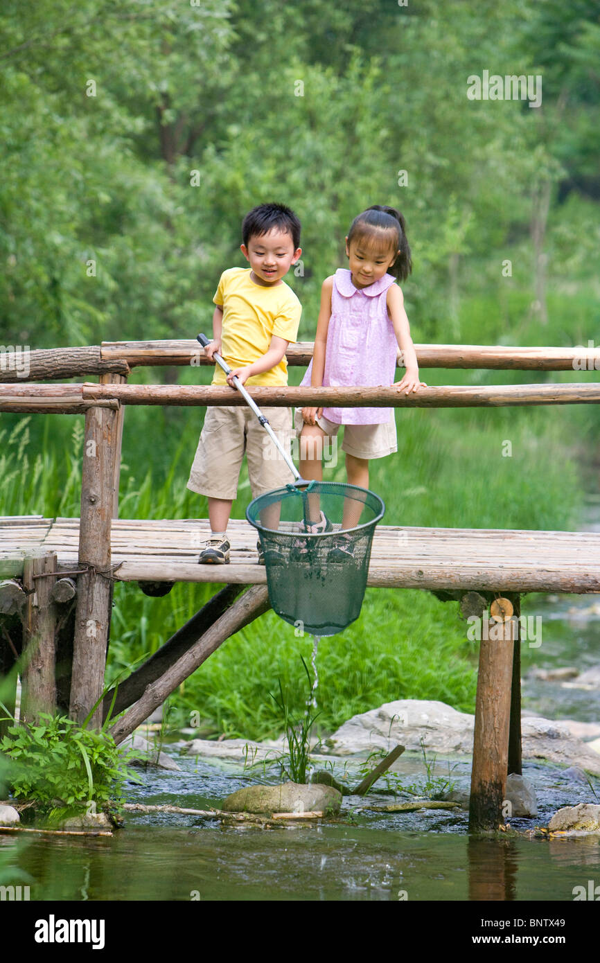 Portrait of two children fishing Stock Photo - Alamy