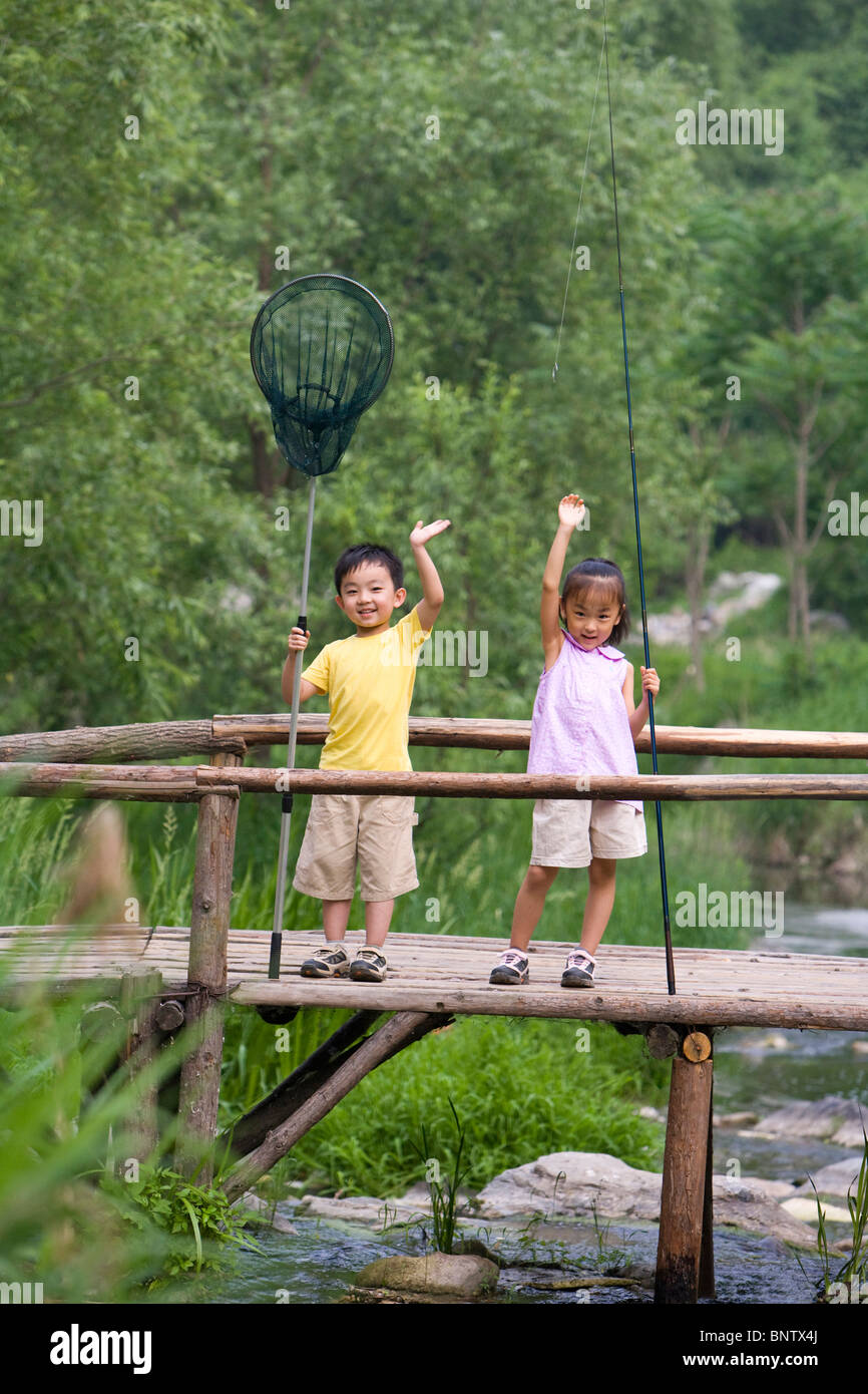 Portrait of two children fishing Stock Photo - Alamy