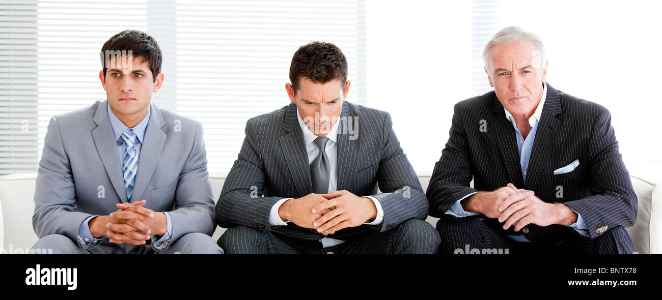 Three charismatic businessmen in a waiting room Stock Photo - Alamy