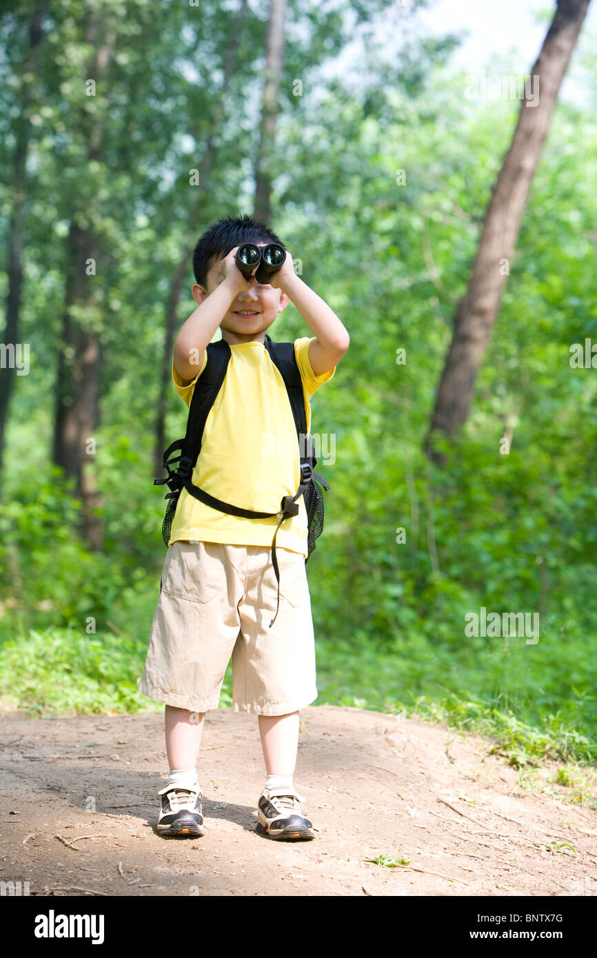 Young boy looking through binoculars Stock Photo - Alamy