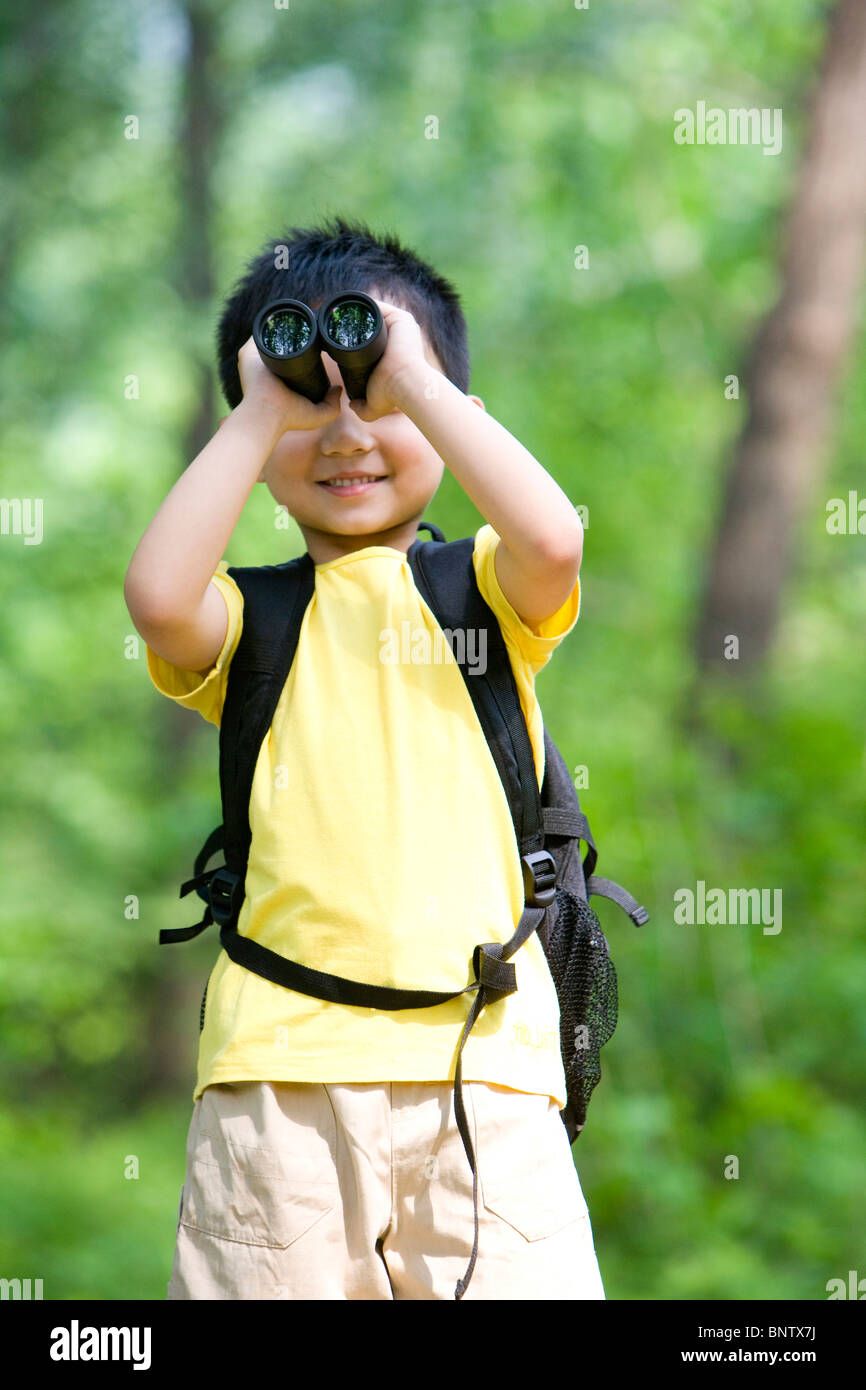 Young boy looking through binoculars Stock Photo - Alamy