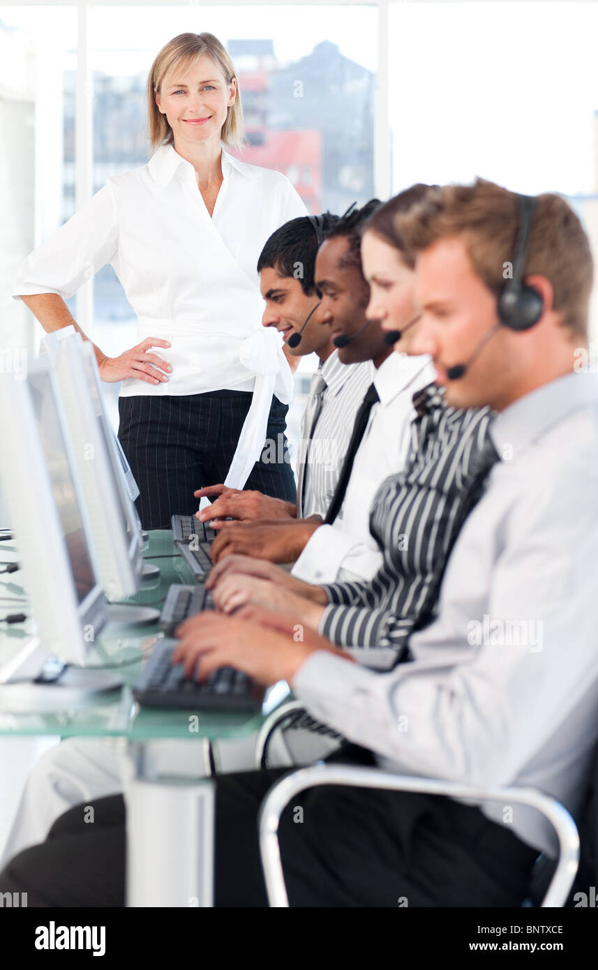 Female leader managing her concentrated team in a call center Stock ...