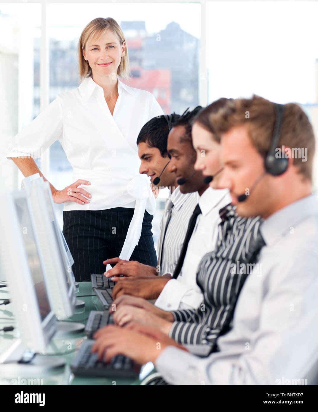 Female leader managing her working team in a call center Stock Photo ...
