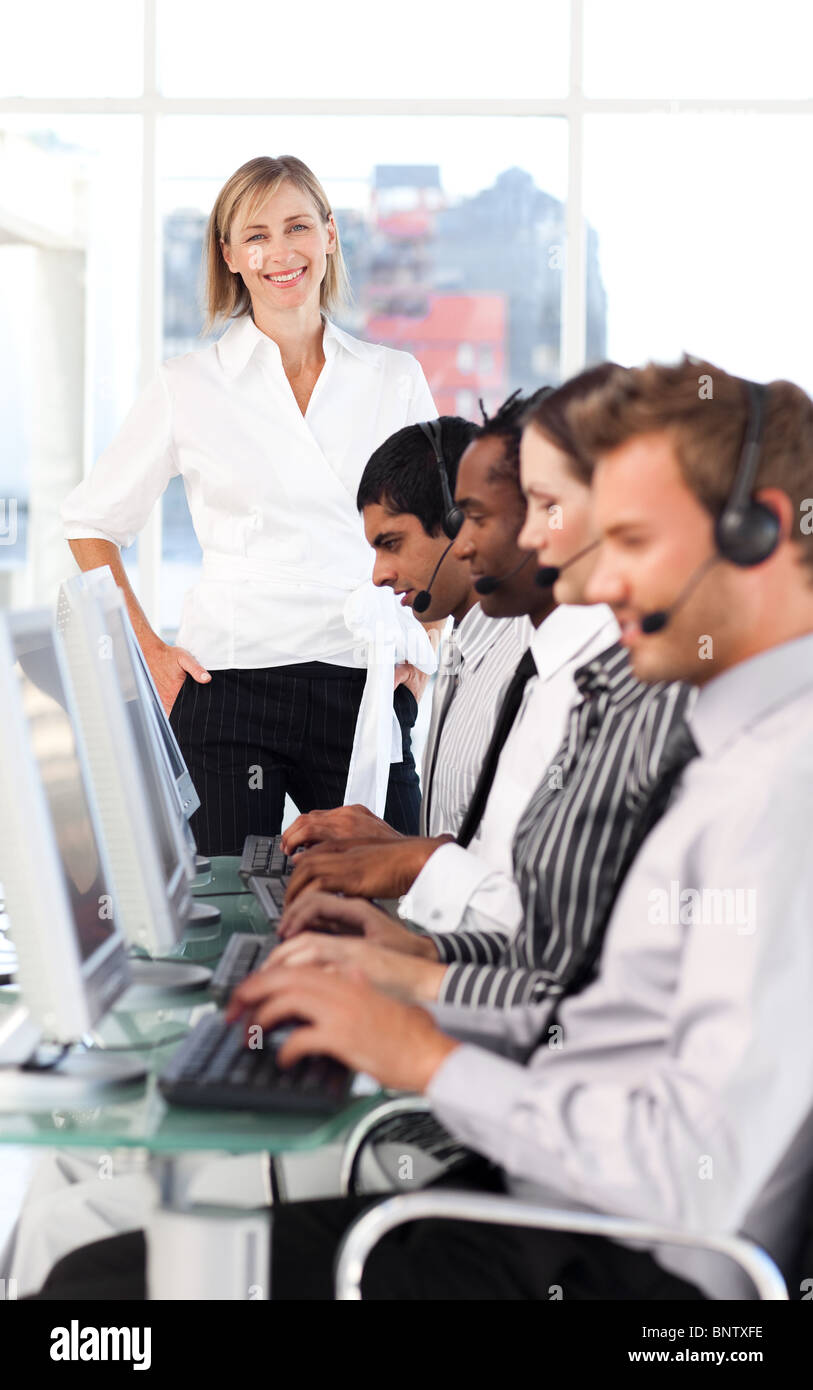 Cheerful female leader with a team on a call center Stock Photo - Alamy