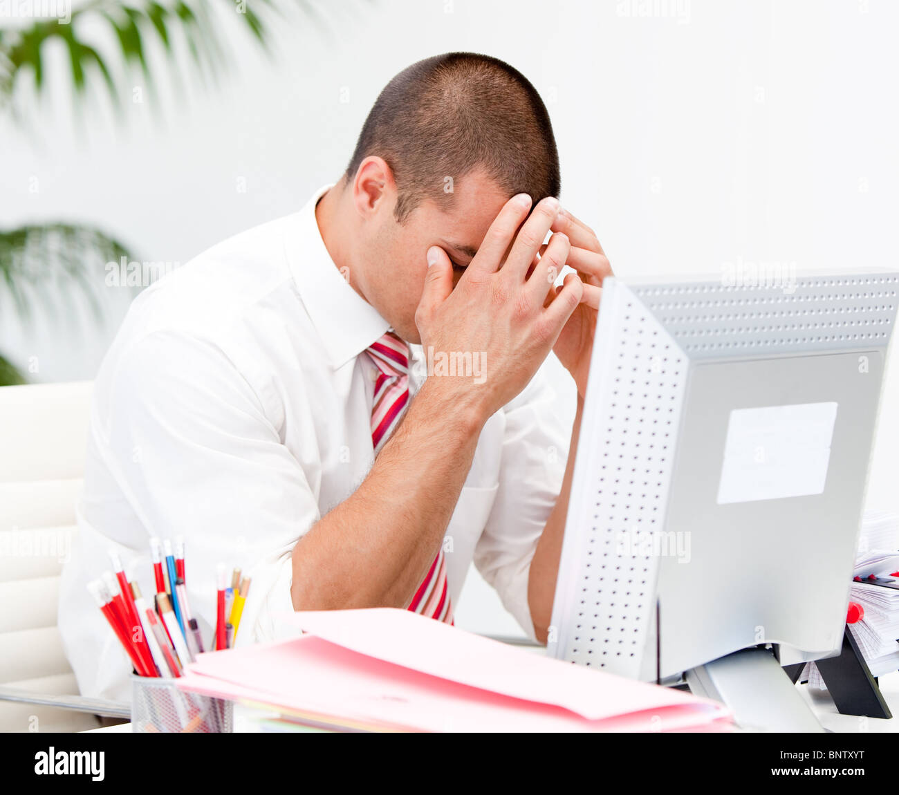 Frustrated businessman working at a computer Stock Photo - Alamy