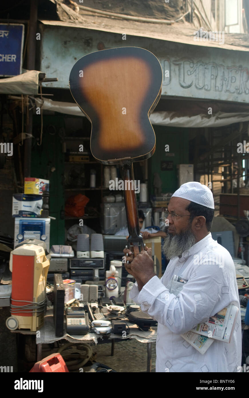 Muslim man carrying guitar at Chor Bazaar, Mumbai, India Stock Photo ...