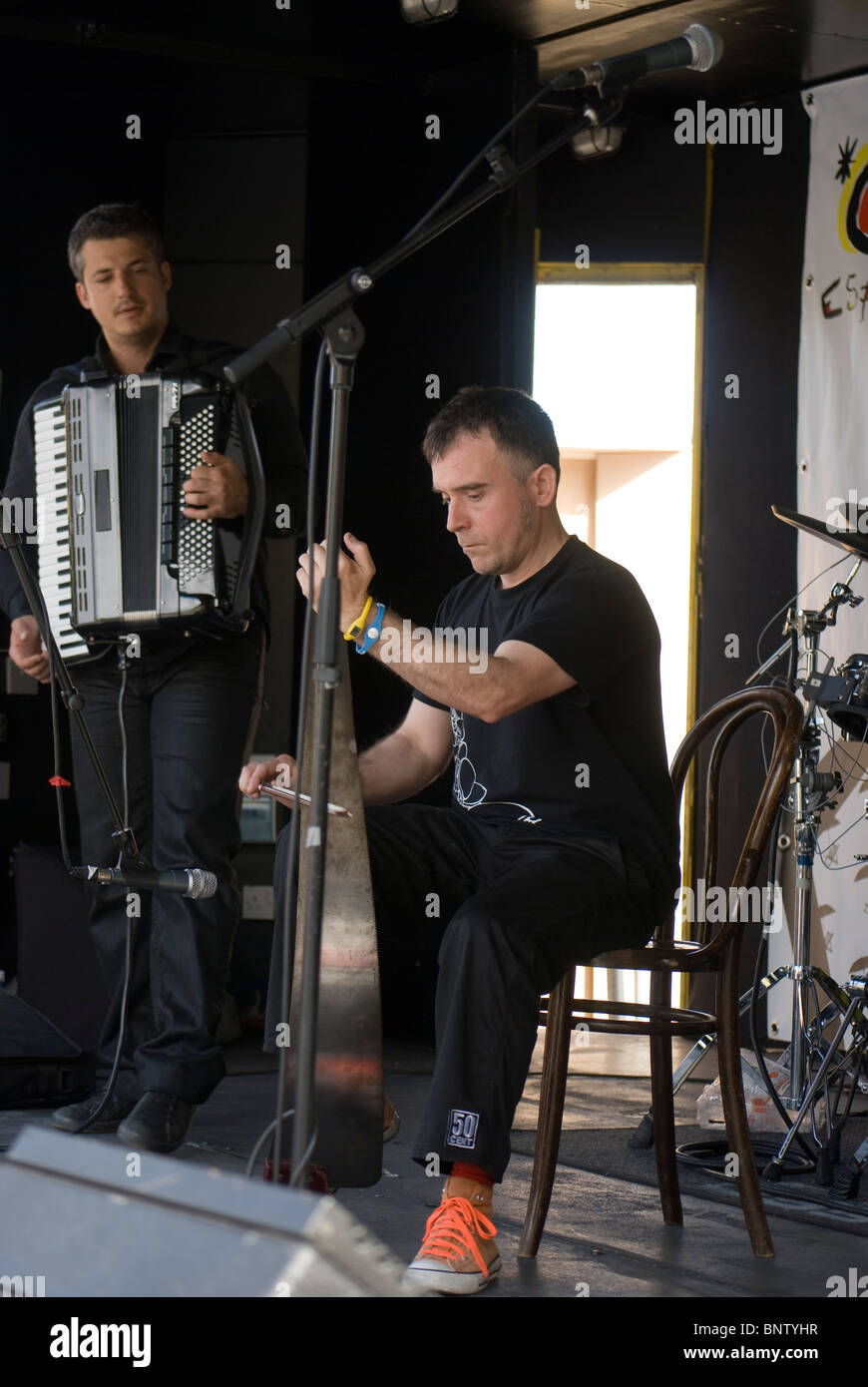 Man playing a musical saw. Part of an event promoting Spanish holidays ...