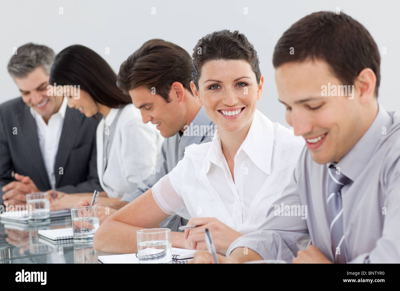 International business people taking notes in a meeting Stock Photo - Alamy