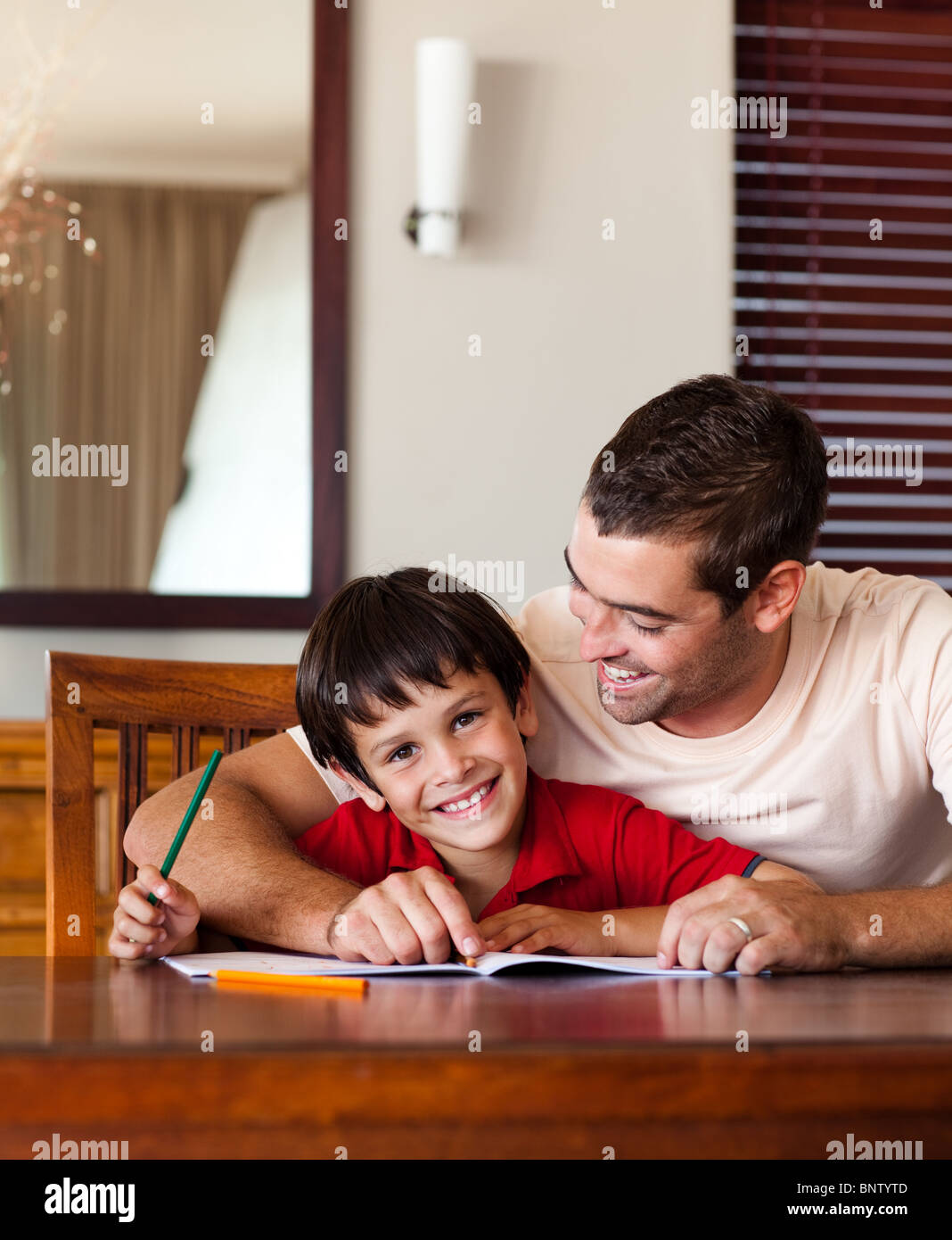 Delighted father helping his son for homework Stock Photo - Alamy