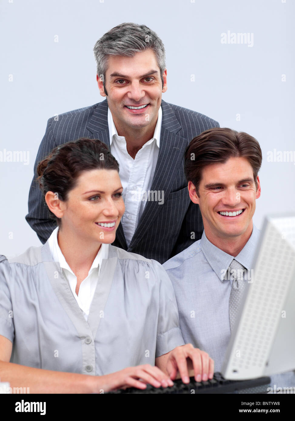 Enthusiastic Business team working at a computer Stock Photo - Alamy
