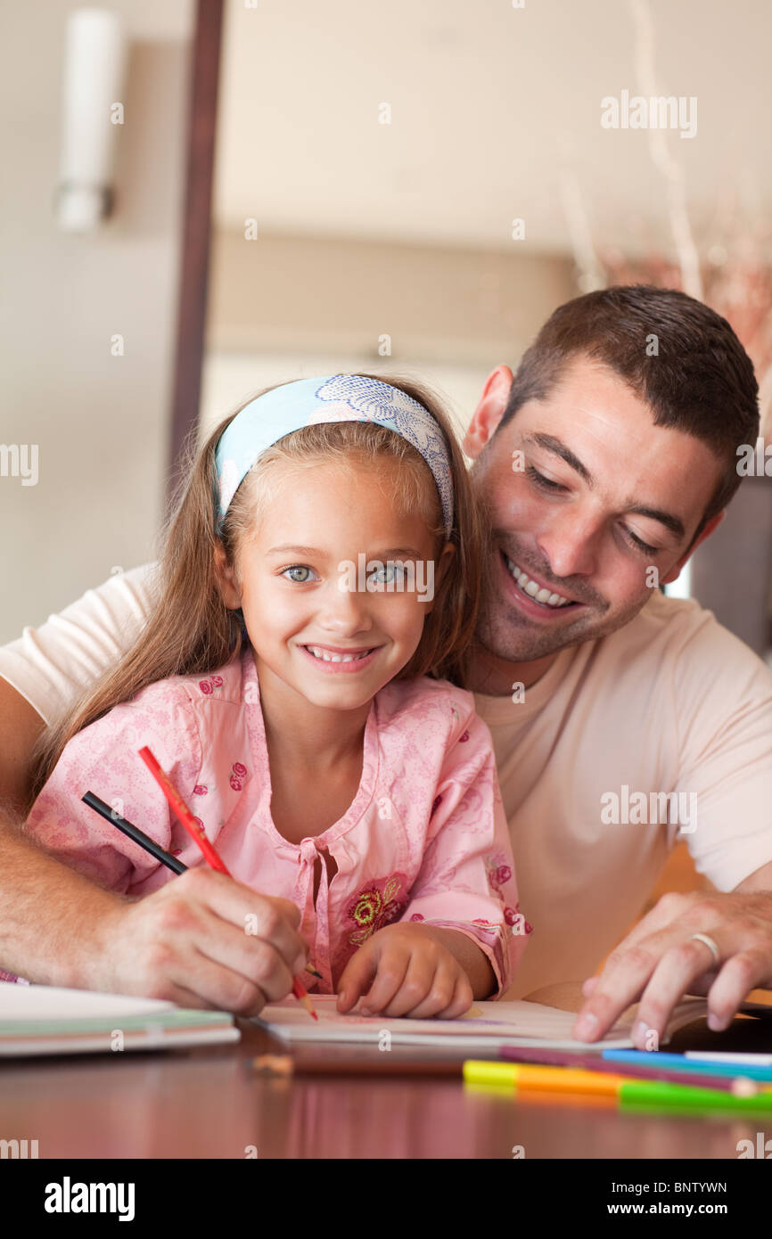 Joyful father helping daughter homework hi-res stock photography and images - Alamy