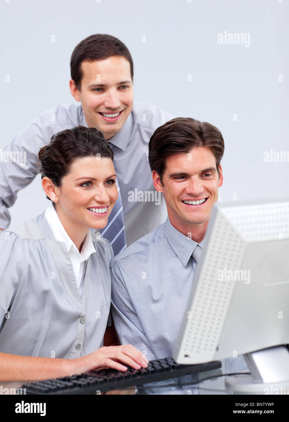 Lucky Business team working at a computer Stock Photo - Alamy