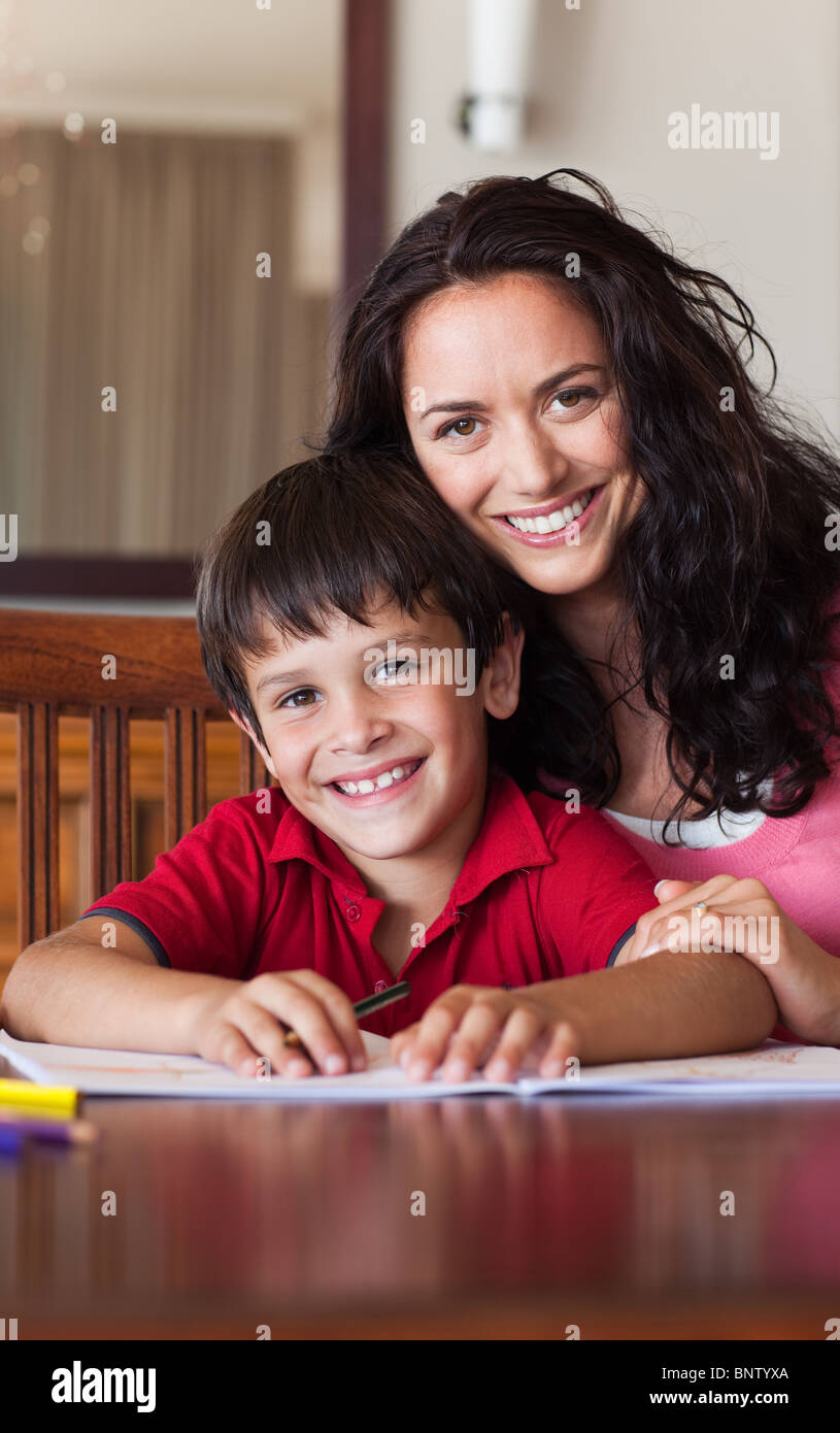 Delighted mother helping his son for homework Stock Photo - Alamy