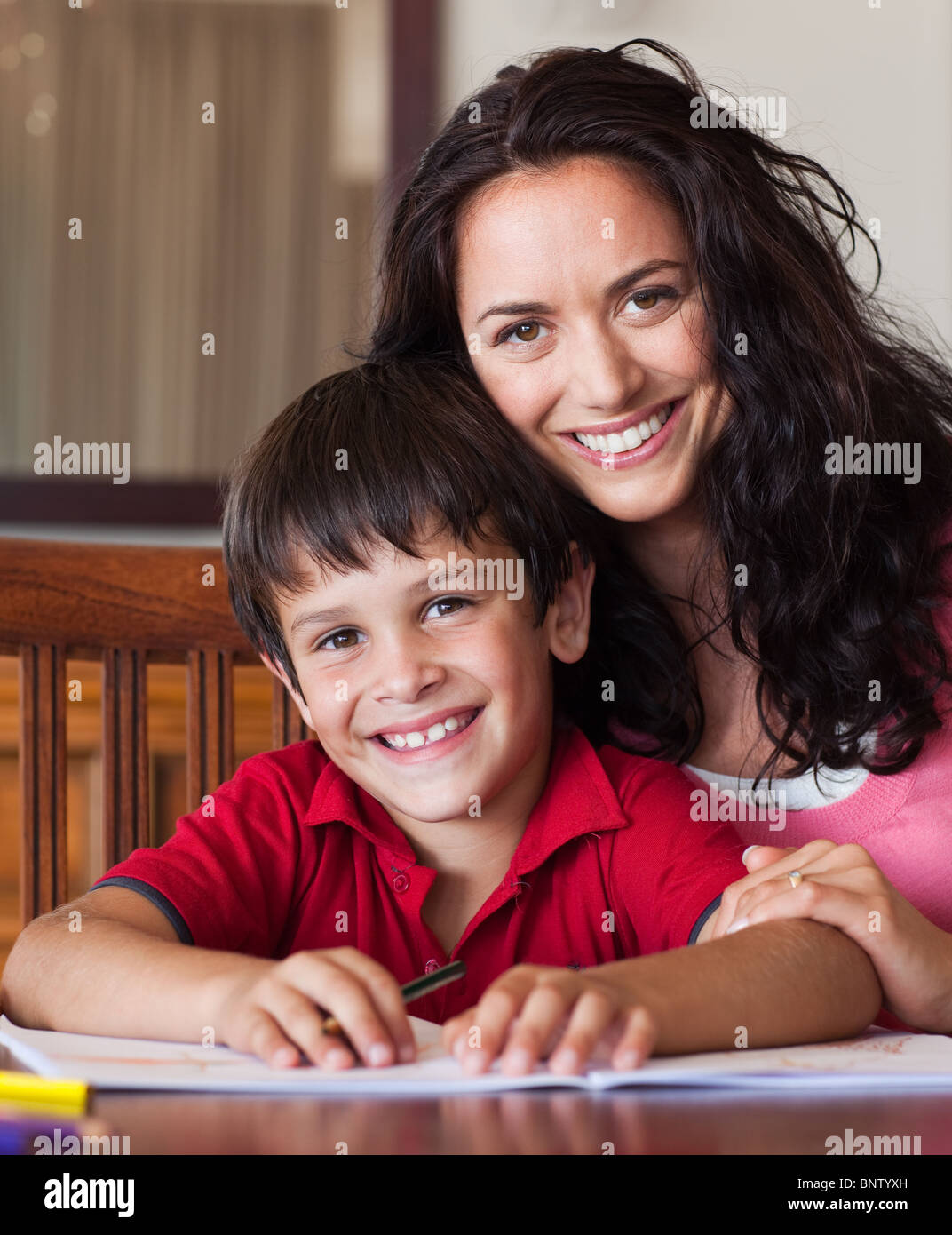 Bright mother helping his son for homework Stock Photo - Alamy