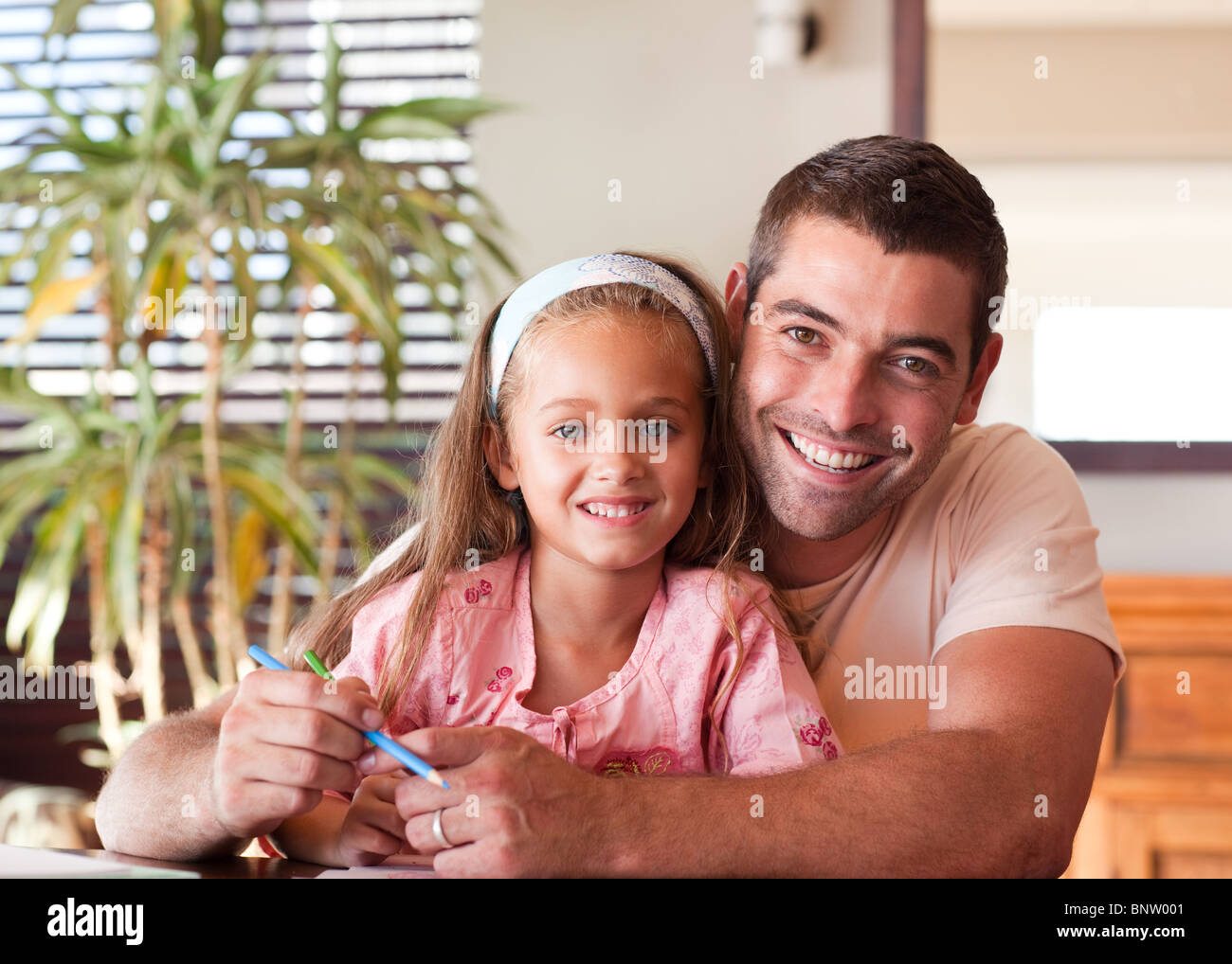Confident father helping her daughter for homework Stock Photo - Alamy