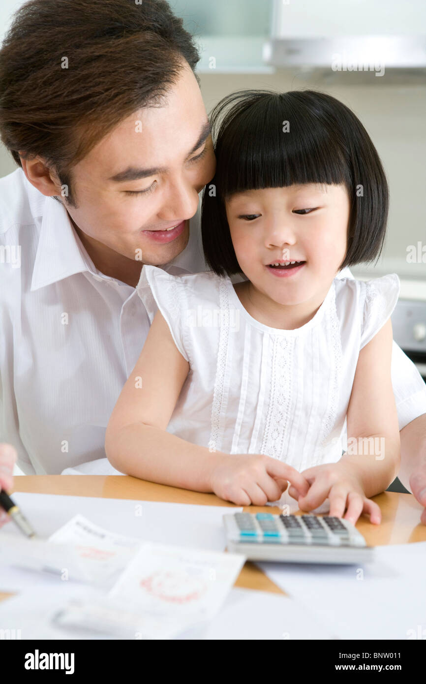 Father and daughter doing the household accounting Stock Photo - Alamy