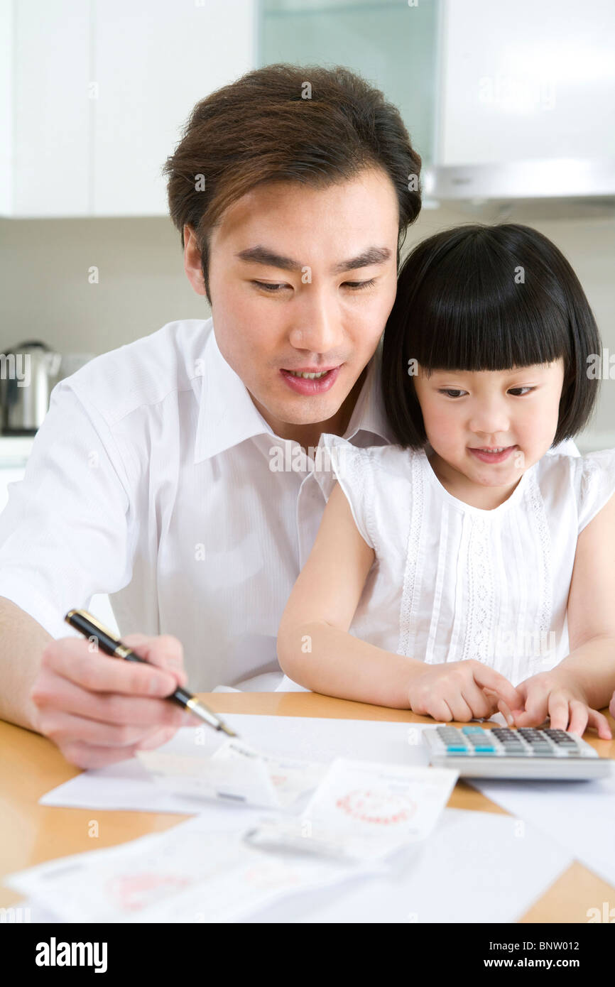 Father and daughter doing the household accounting Stock Photo - Alamy