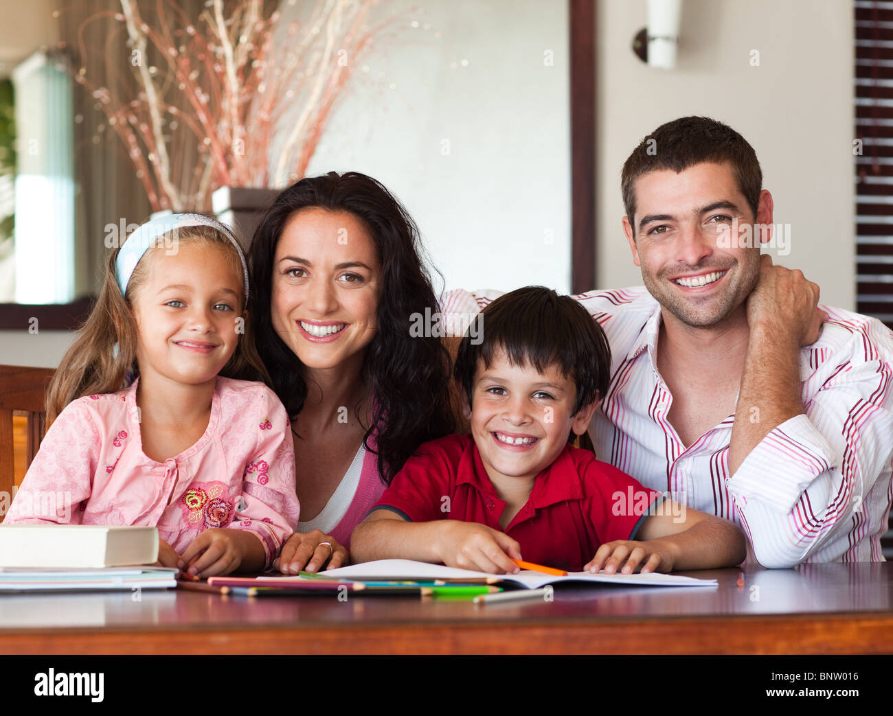 Nice parents helping their children for homework Stock Photo - Alamy