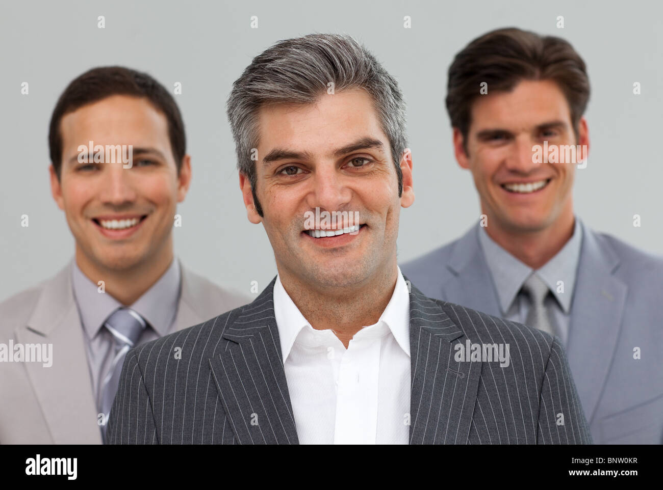 Serious Business co-workers standing in a line Stock Photo - Alamy