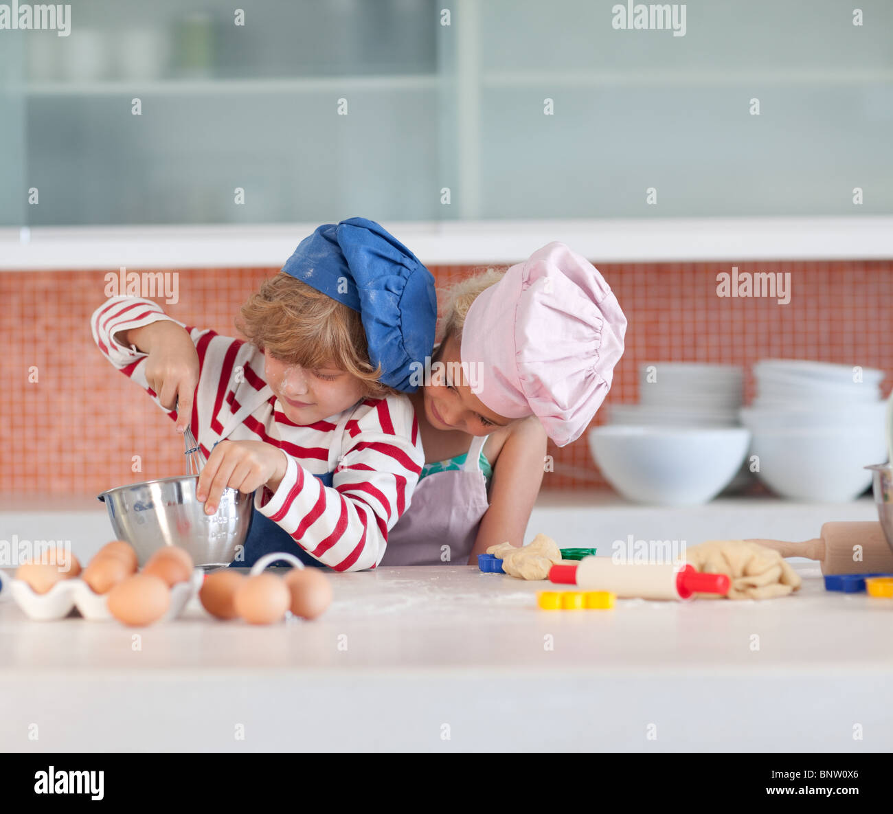 Young children baking at home Stock Photo - Alamy