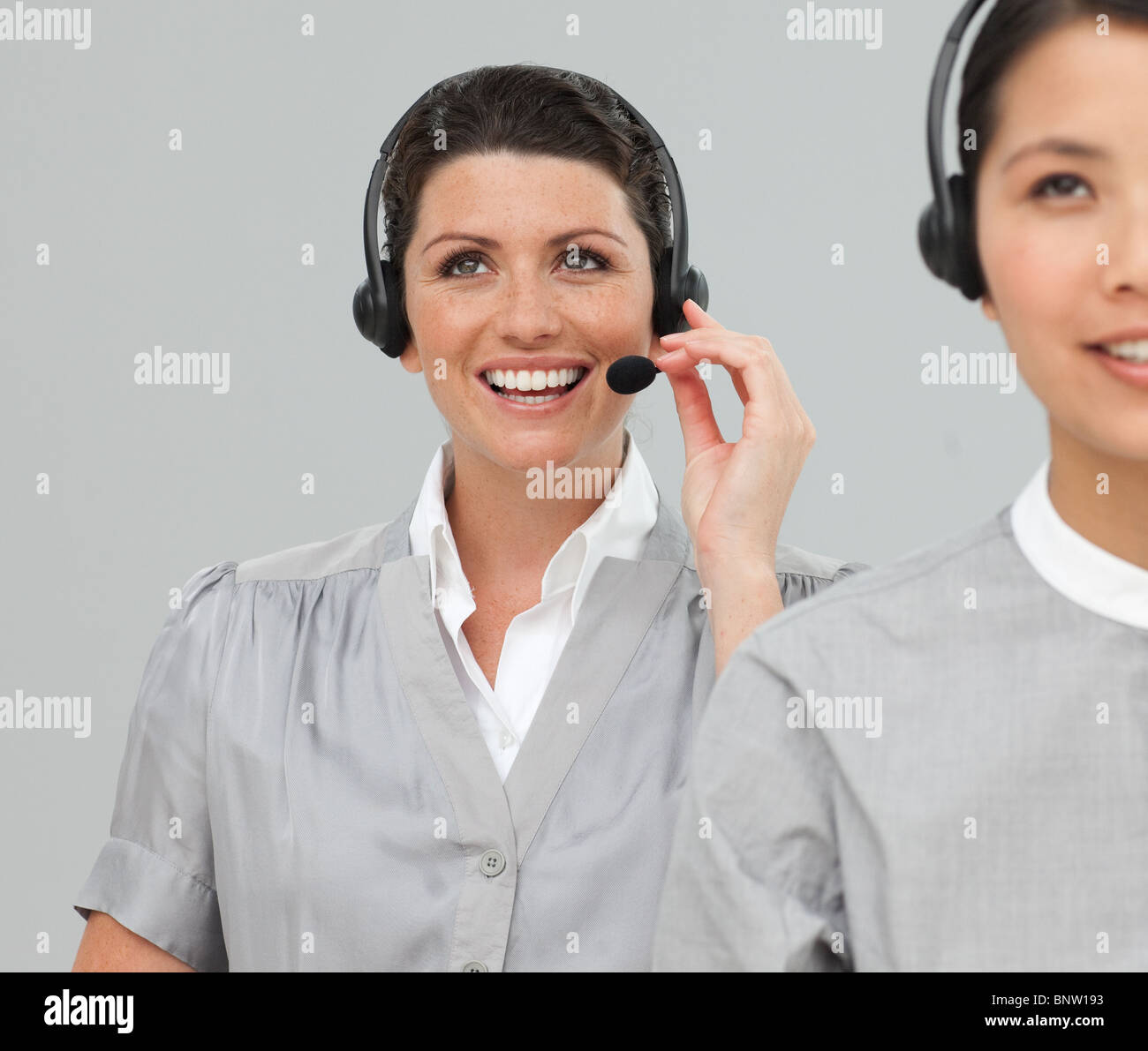 Two Customer service agents with headset on Stock Photo - Alamy