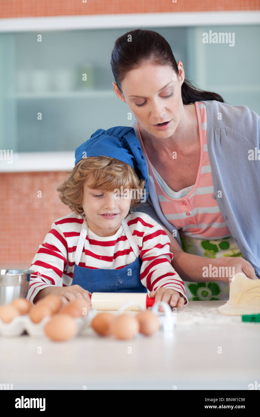 Beautiful mother and her son baking at home Stock Photo - Alamy