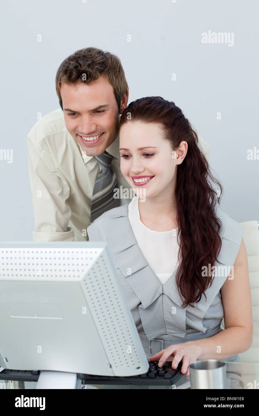 Attractive business people using a computer Stock Photo - Alamy