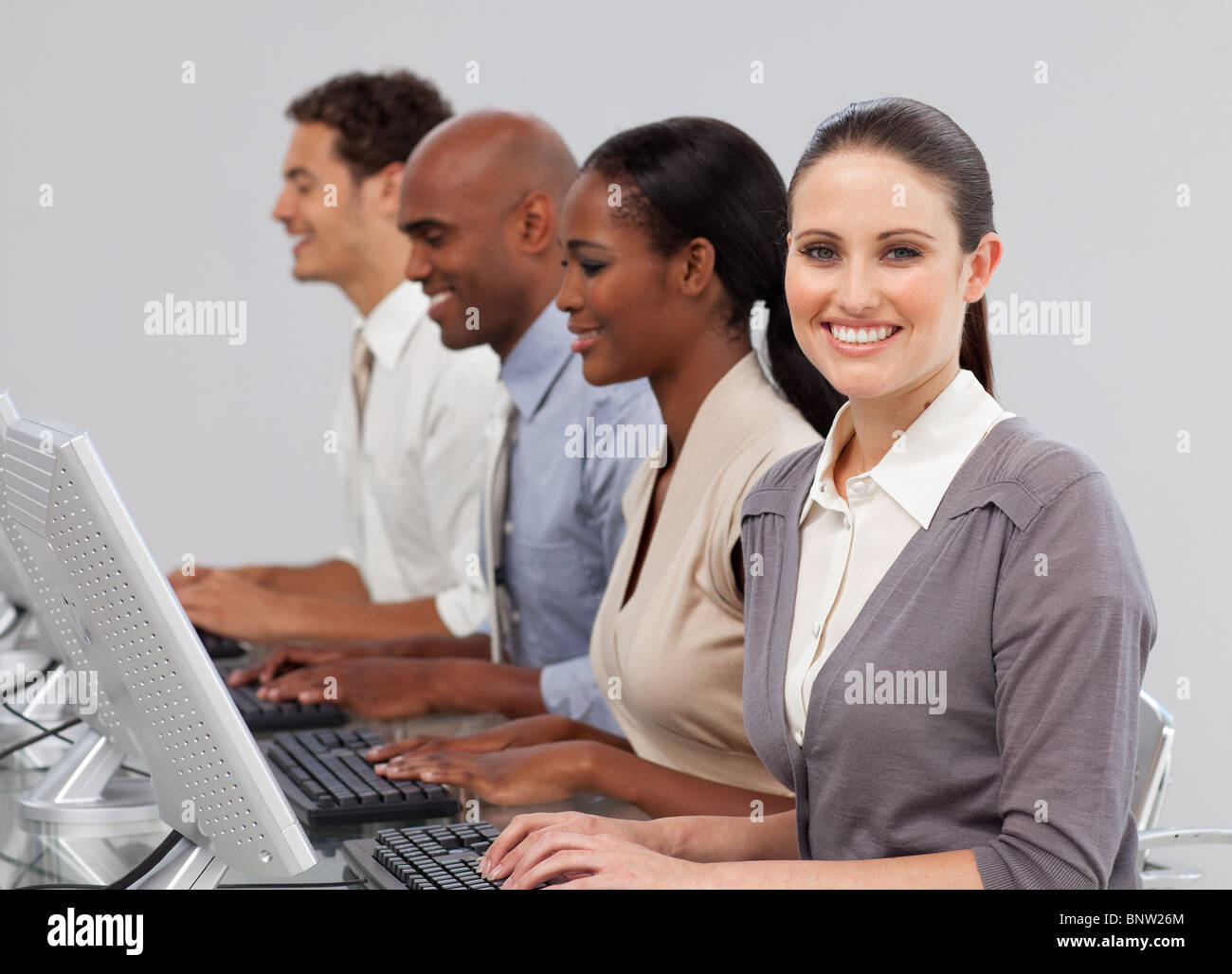 International business people in a line working at computers Stock ...