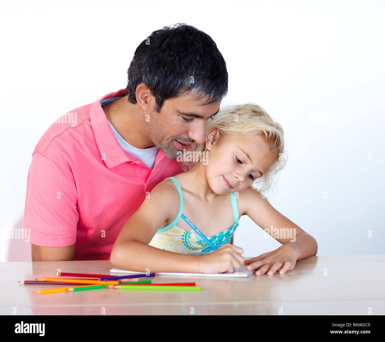 Good-looking father drawing with his daughter Stock Photo - Alamy