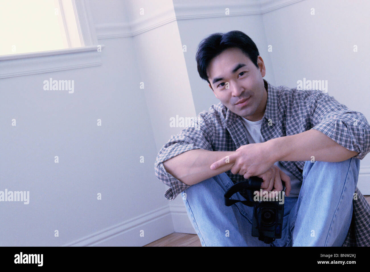 Relaxed man sitting on the floor in his home Stock Photo - Alamy