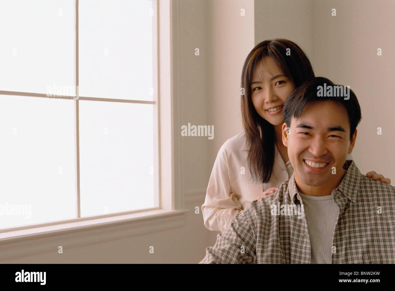 Couple standing facing camera hi-res stock photography and images - Alamy