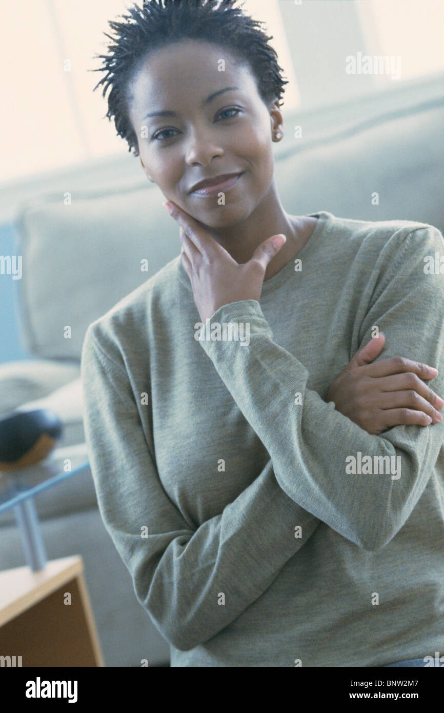 Beautiful woman standing in her home Stock Photo - Alamy