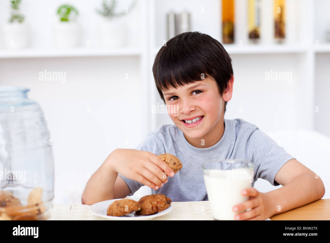 Smiling boy eating cookies Stock Photo - Alamy