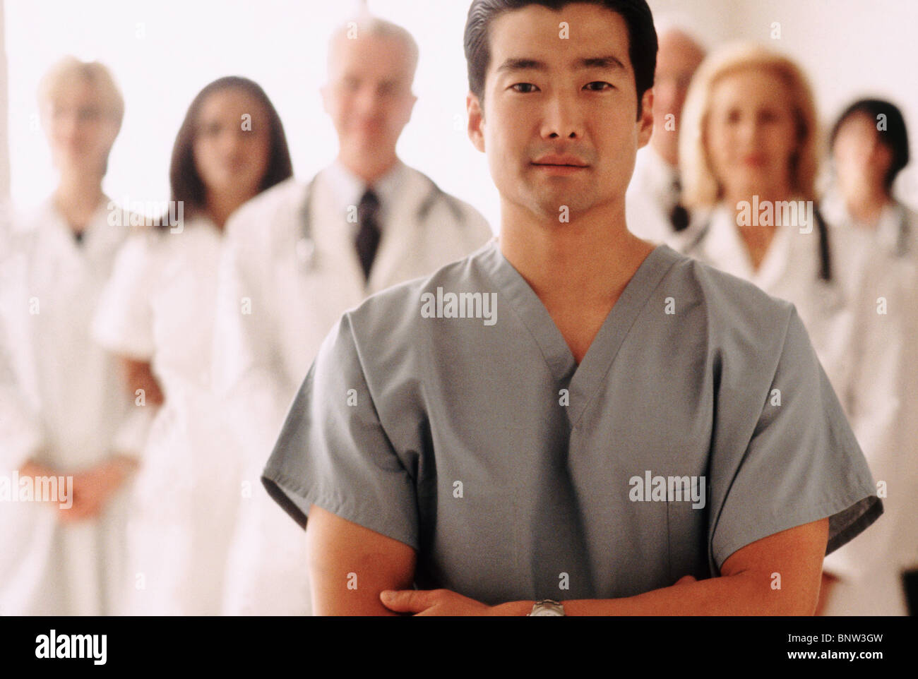 Doctor standing in front of medical team Stock Photo - Alamy